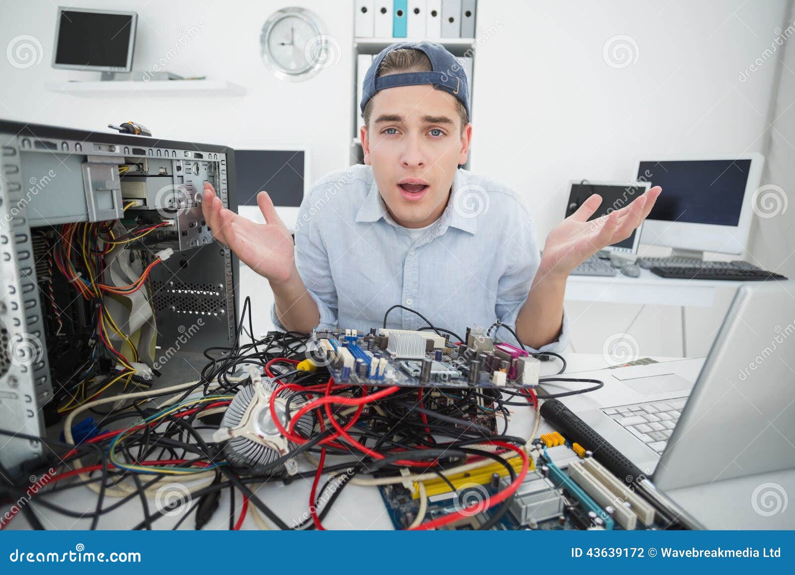 Confused Computer Engineer Working on Broken Console with Laptop Stock ...