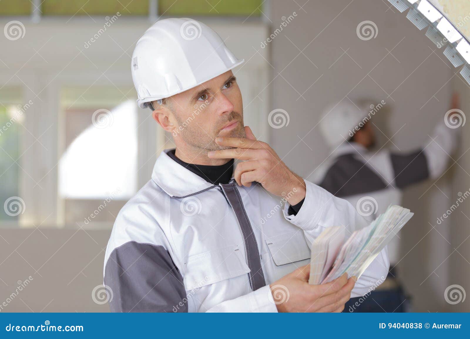 Confused Construction Worker Holding Spirit Level in New House Stock ...