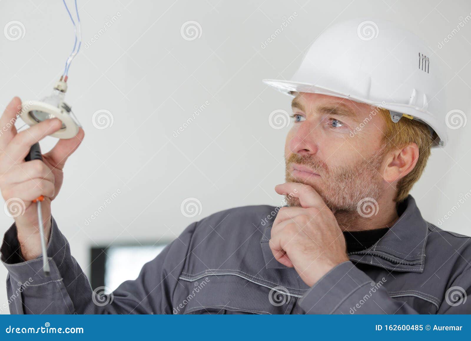 Confused Contractor Installing Spotlight Stock Image - Image of ...