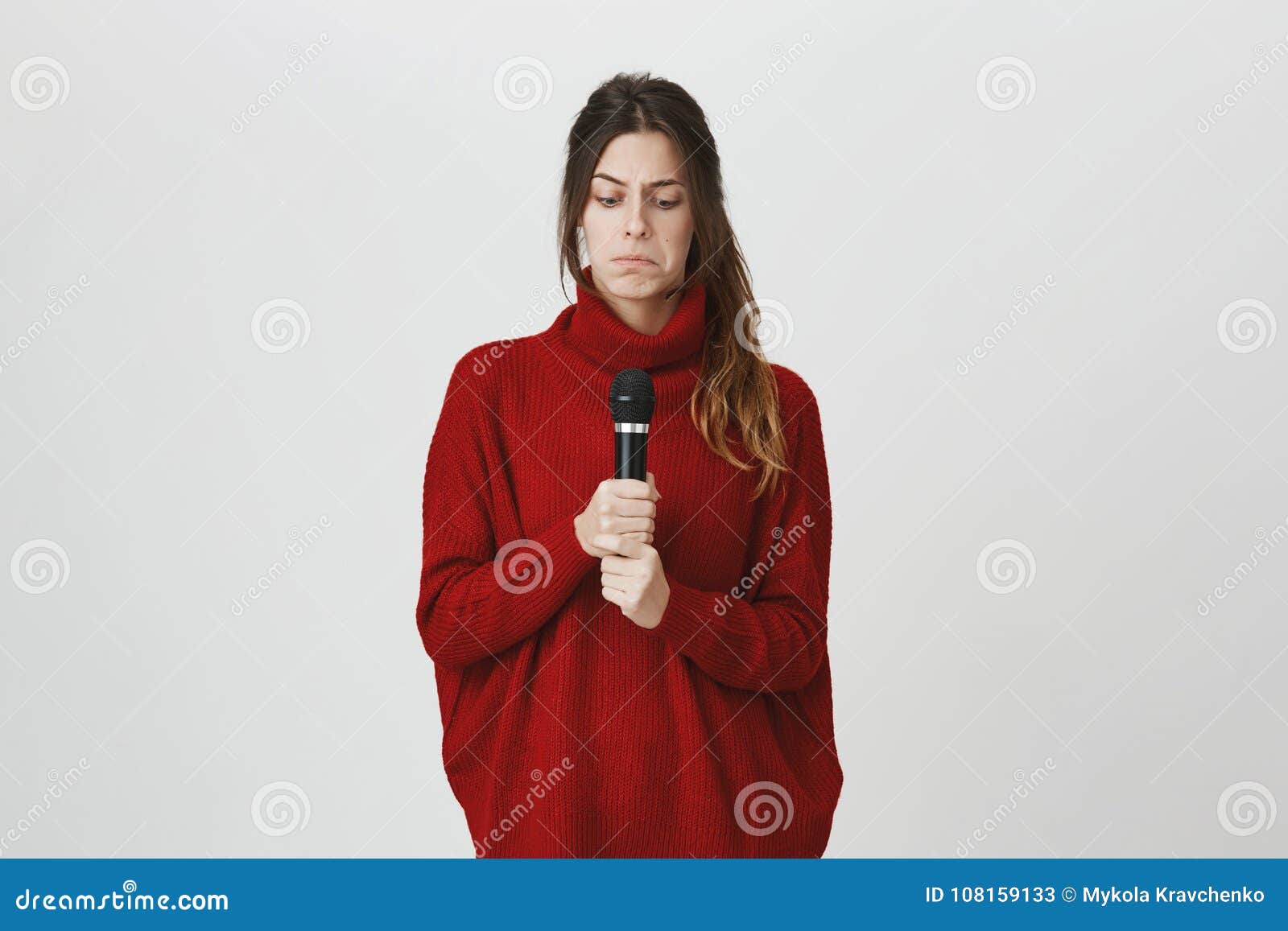 Confused Cute Female with Perplexed Expression Looking at Microphone ...
