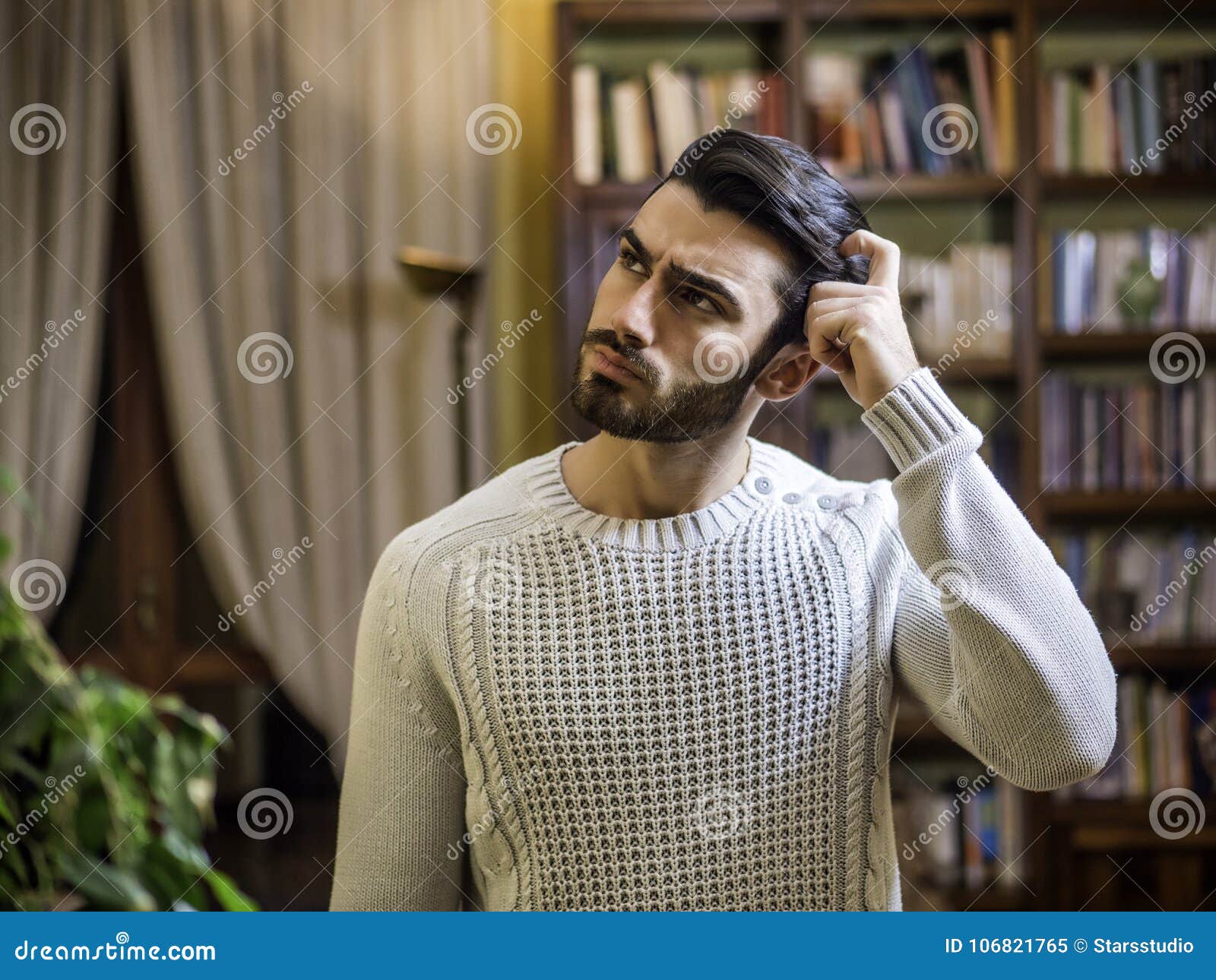 Confused Or Doubtful Young Man Scratching His Head And Looking Up Stock