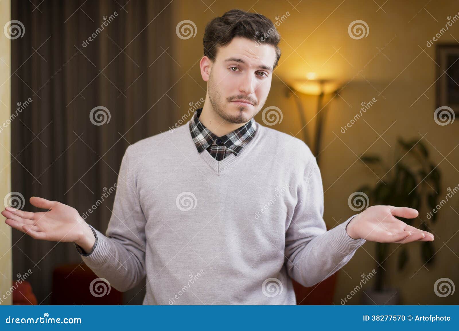 Confused or Doubtful Young Man Shrugging with Palms Open Stock Photo ...