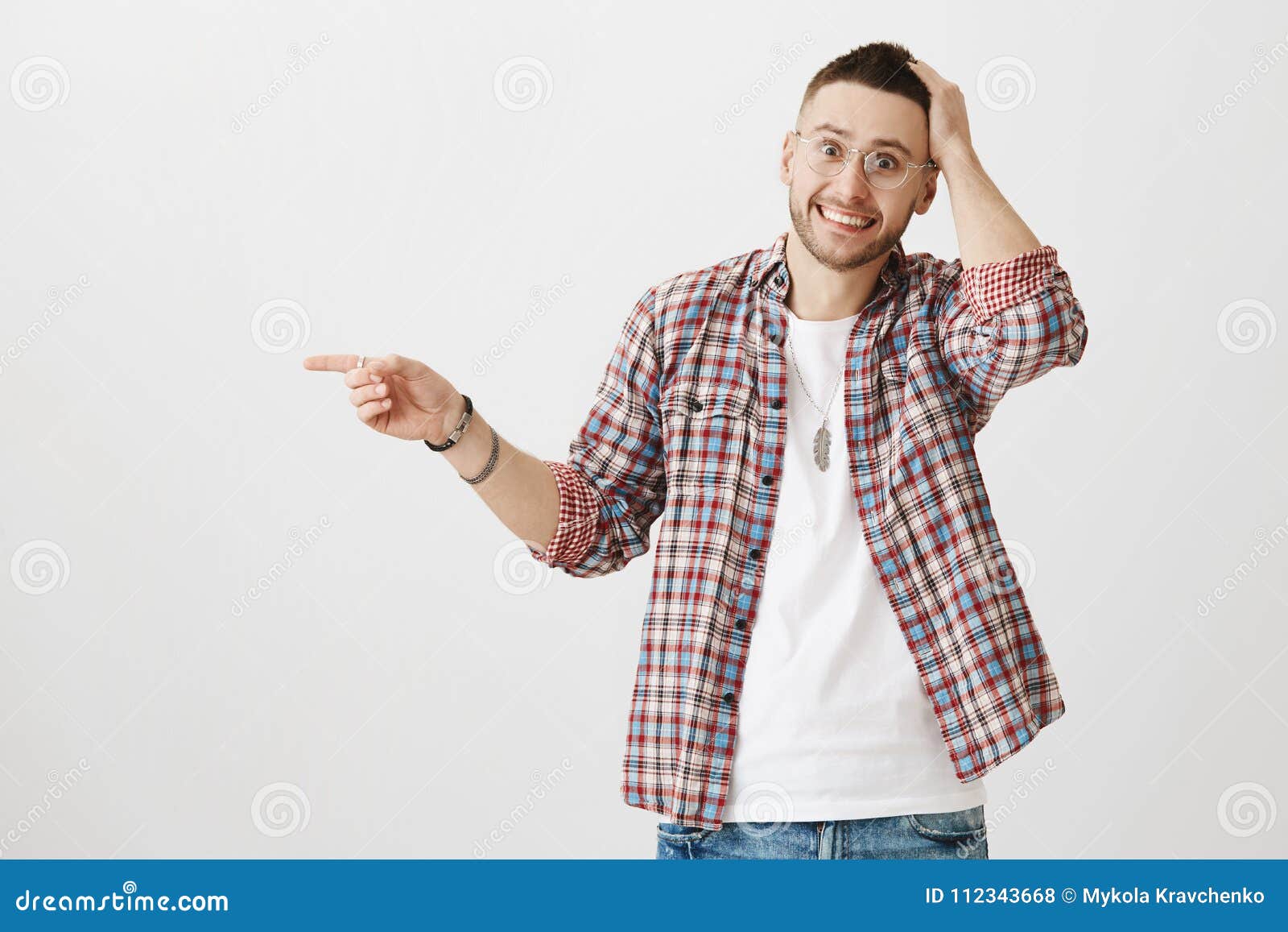 Confused Embarrassed Attractive Man In Glasses Pointing Left While