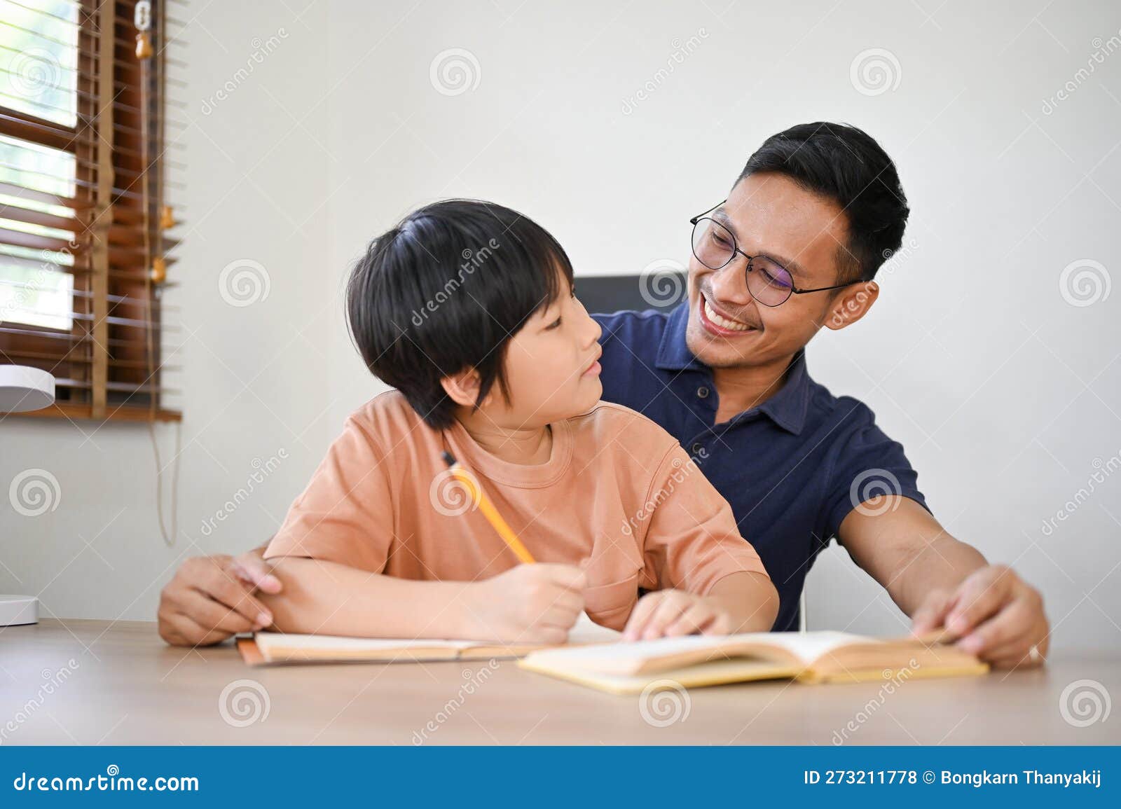 Confused Little Son Asking a Question while His Dad is Helping Him Do ...