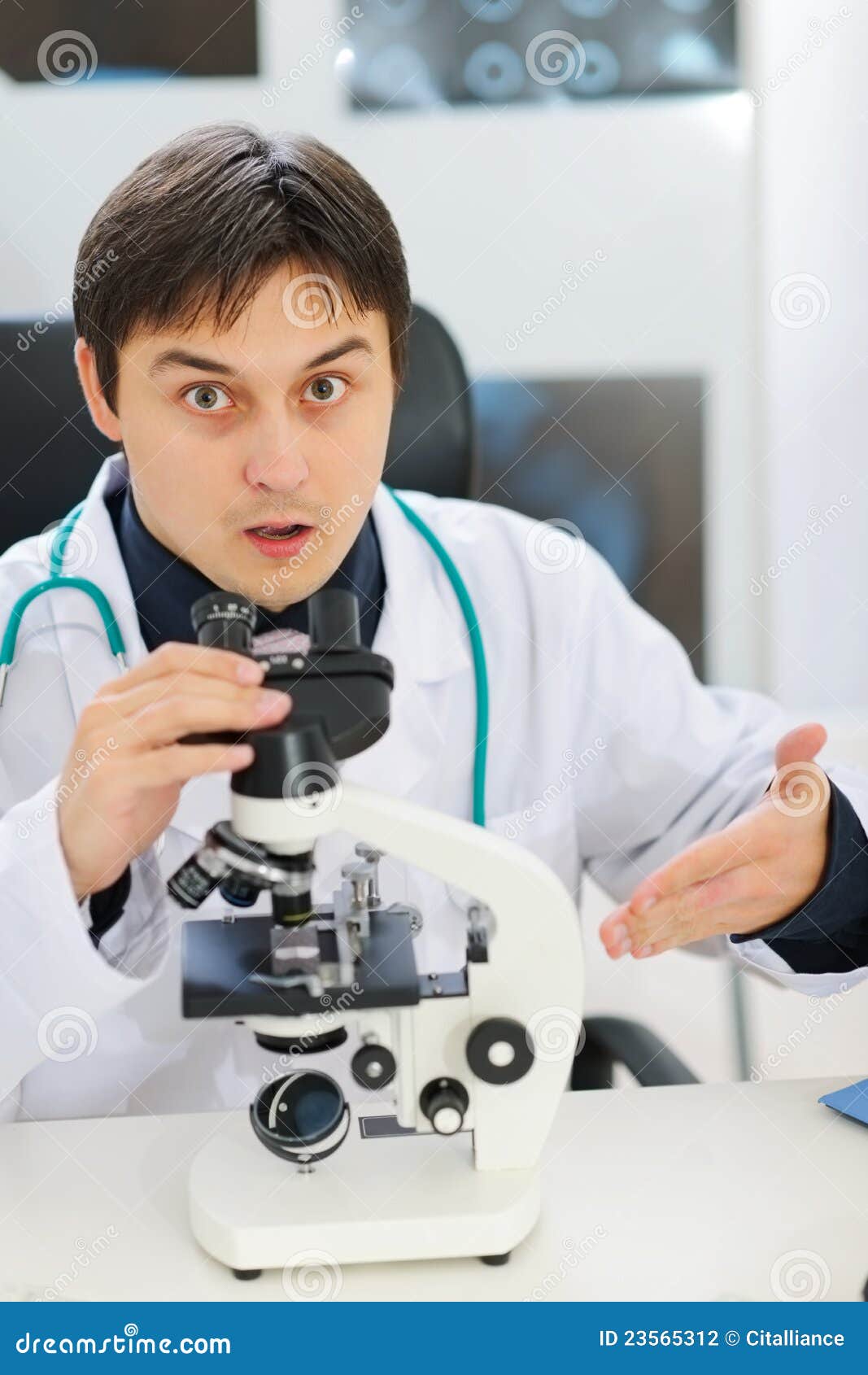 Confused Male Researcher Pointing on Microscope Stock Photo - Image of ...