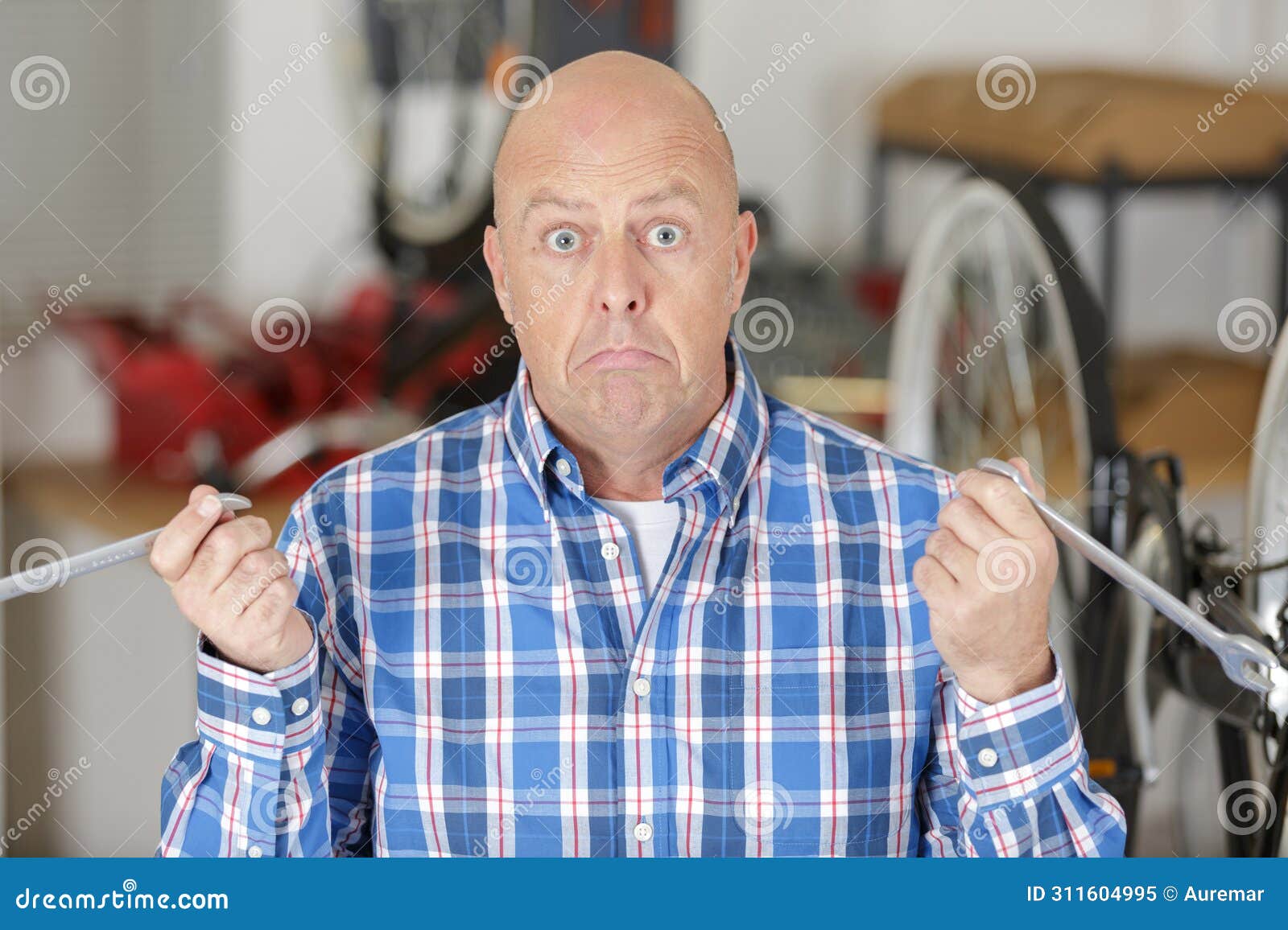 Confused man in workshop stock image. Image of helpful - 311604995