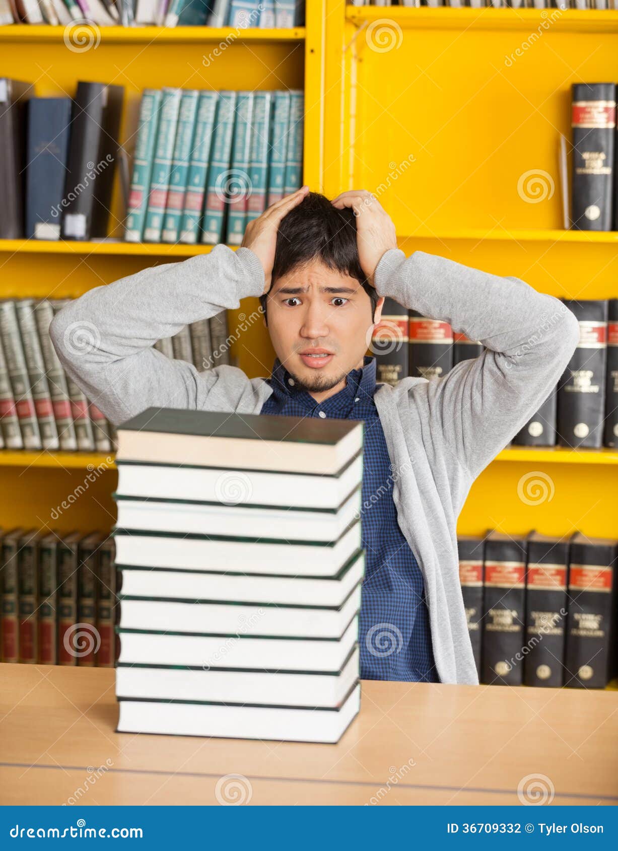 Confused Man Looking at Stacked Books in Library Stock Photo - Image of ...