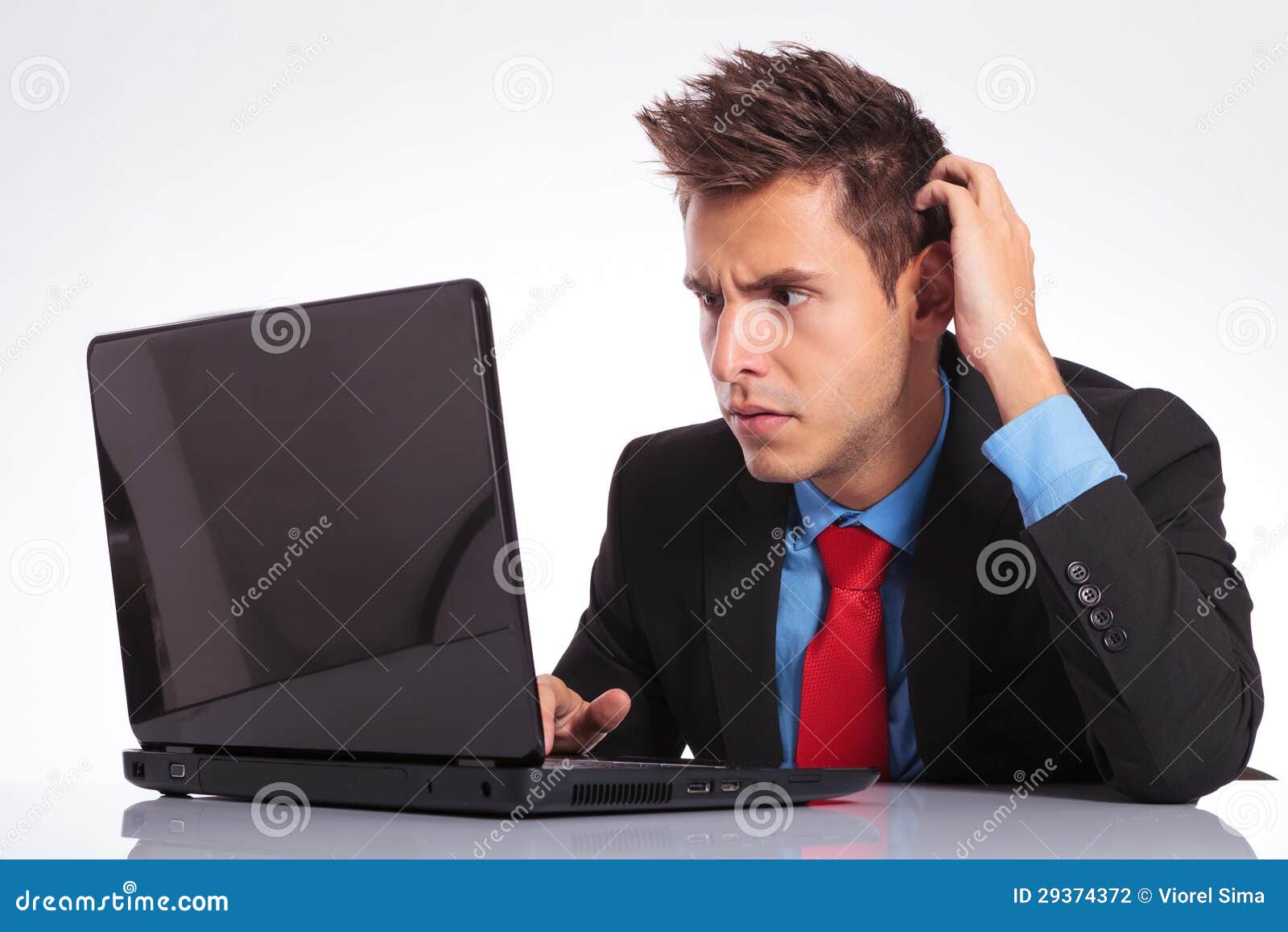 Confused Man Looks at Laptop Stock Photo - Image of latin, isolated ...