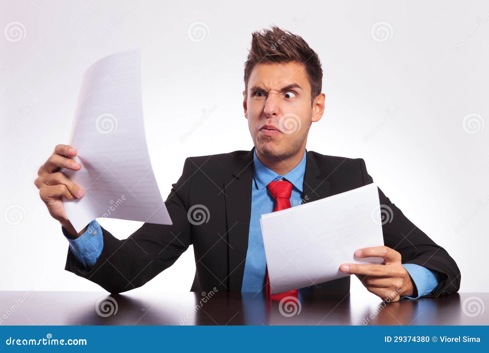 Confused Man Reading At Desk Stock Photo | CartoonDealer.com #29374380