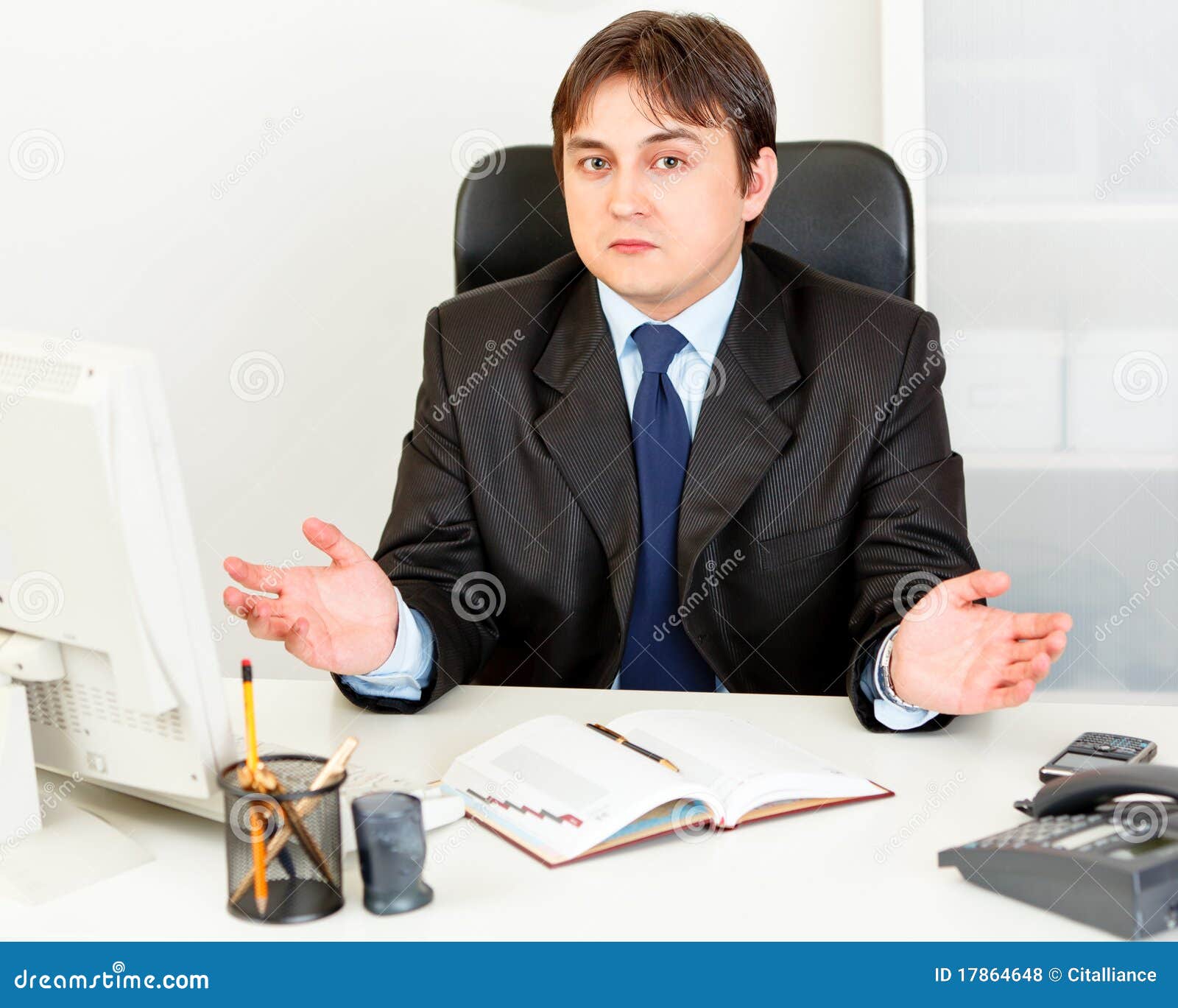 Confused Modern Business Man Sitting at Desk Stock Photo - Image of ... Confused Modern Business Man Sitting at Desk Stock Photo - Image of ...