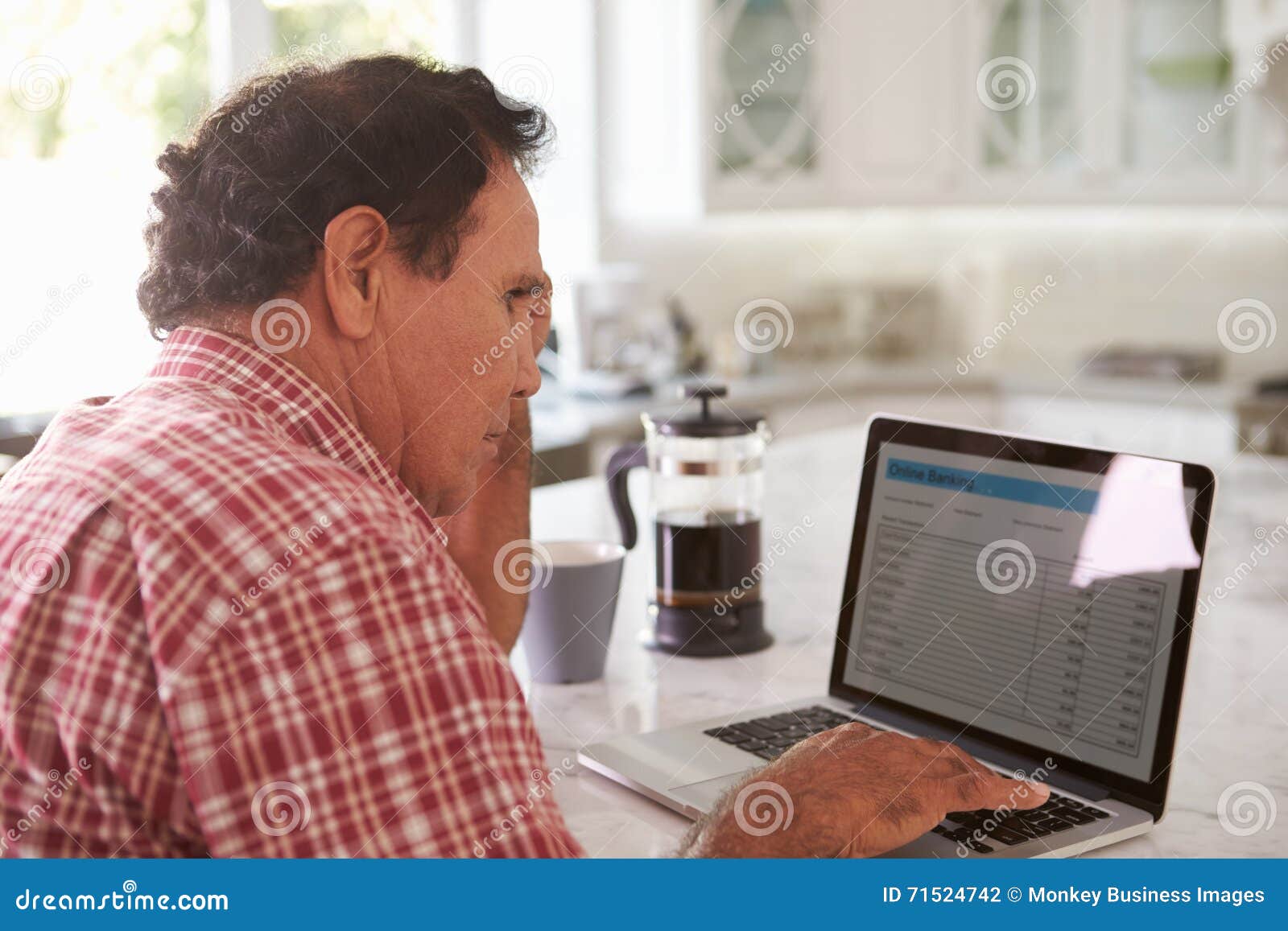 Confused Senior Hispanic Man Sitting at Home Using Laptop Stock Photo ...