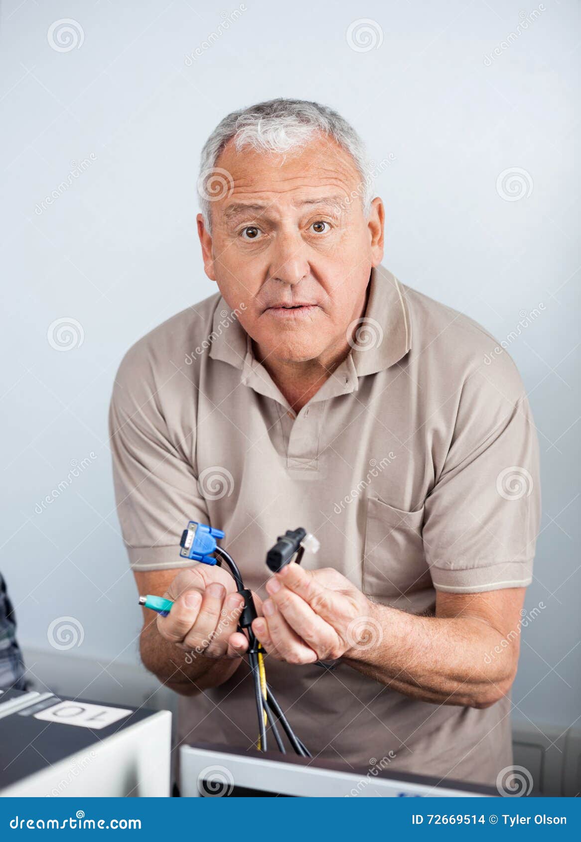 Confused Senior Man Holding Computer Cables in Class Stock Photo ...