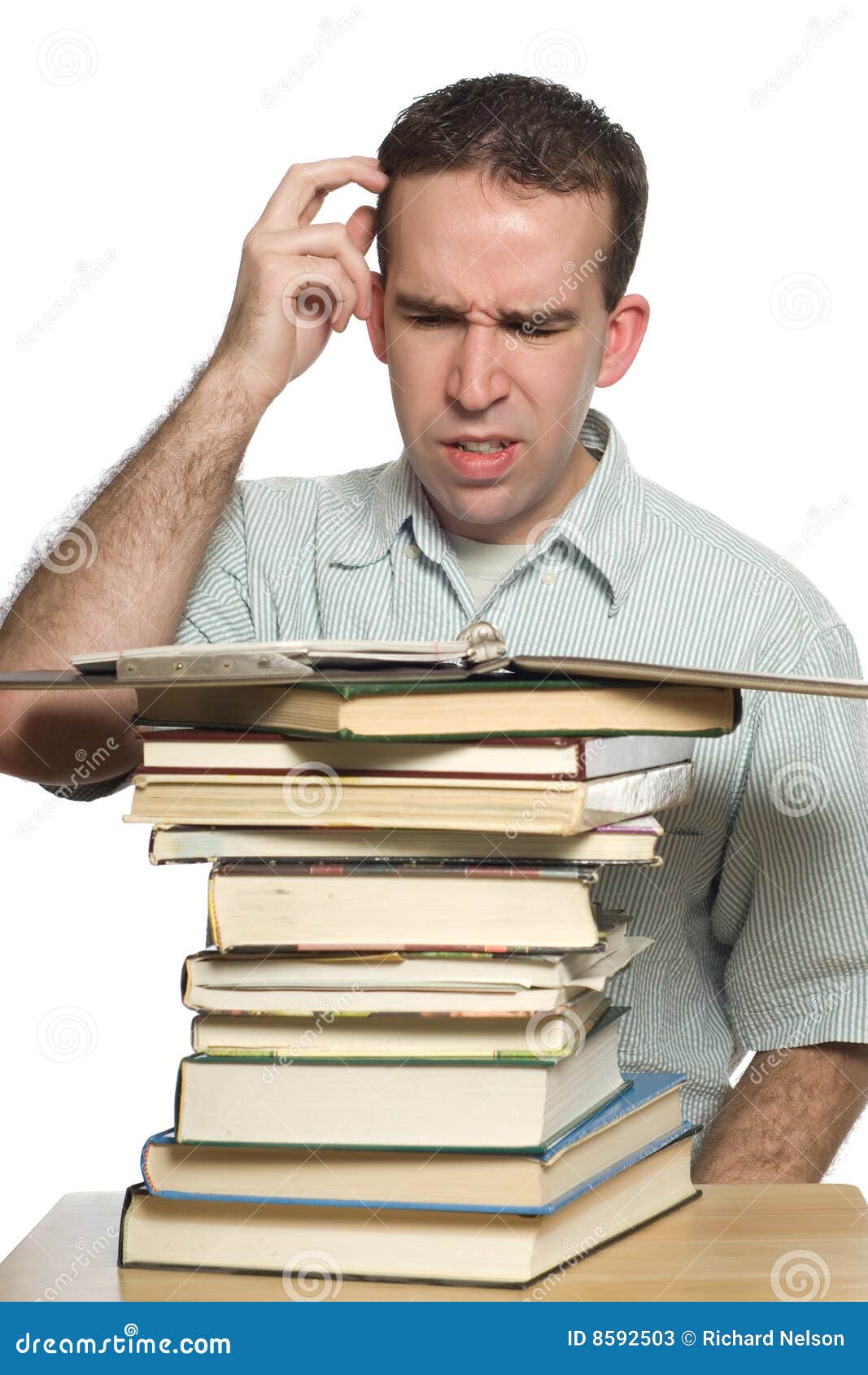 Confused Student Guy Looks Down Upset, Holding A Book With Question ...