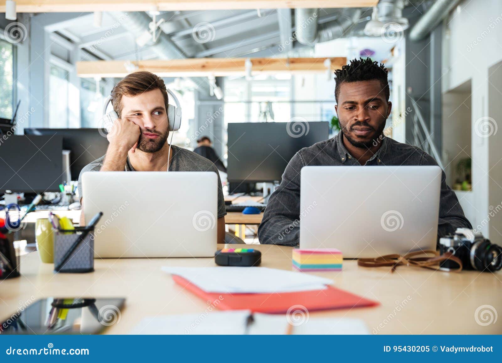 Confused Young Colleagues Sitting in Office Coworking Stock Image ...