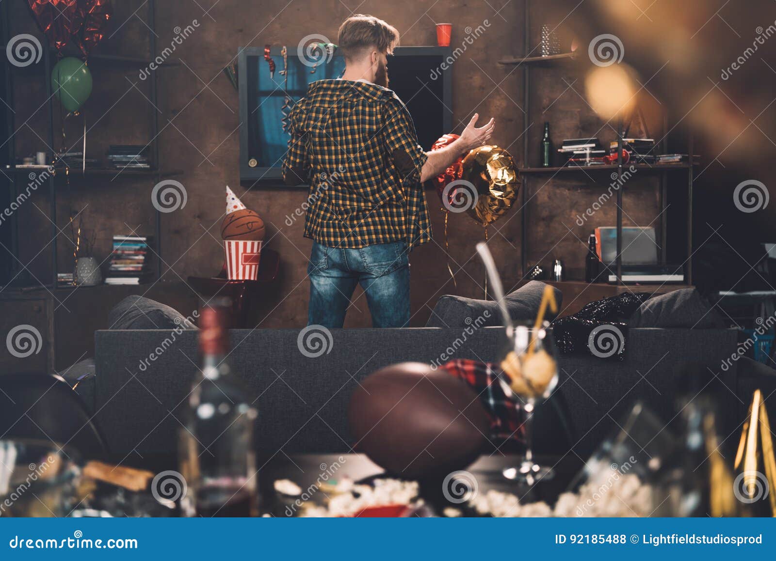 Confused Young Man Gesturing while Standing in Messy Room after Party ...