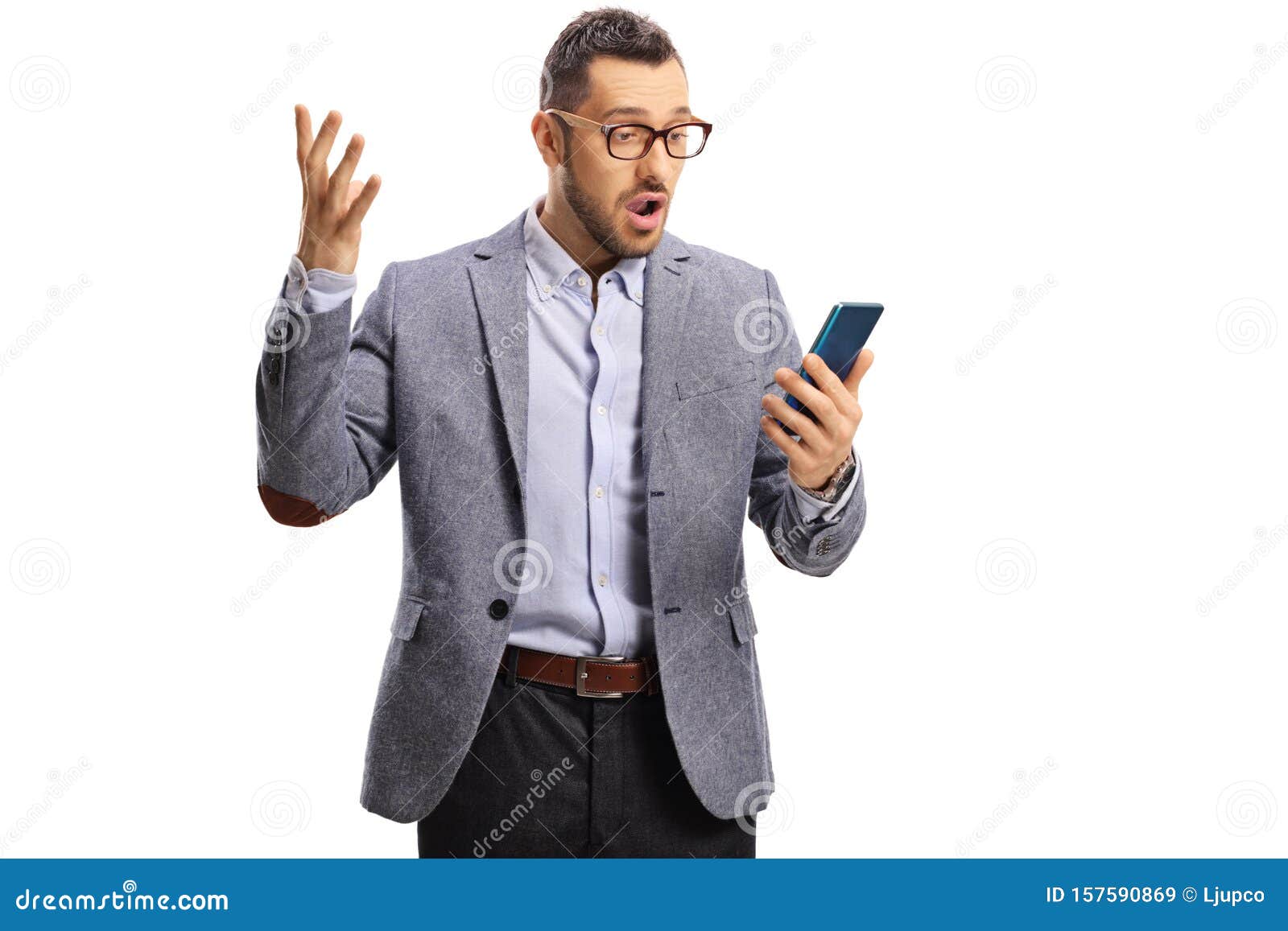 Confused Young Man Looking At His Mobile Phone And Gesturing With Hand