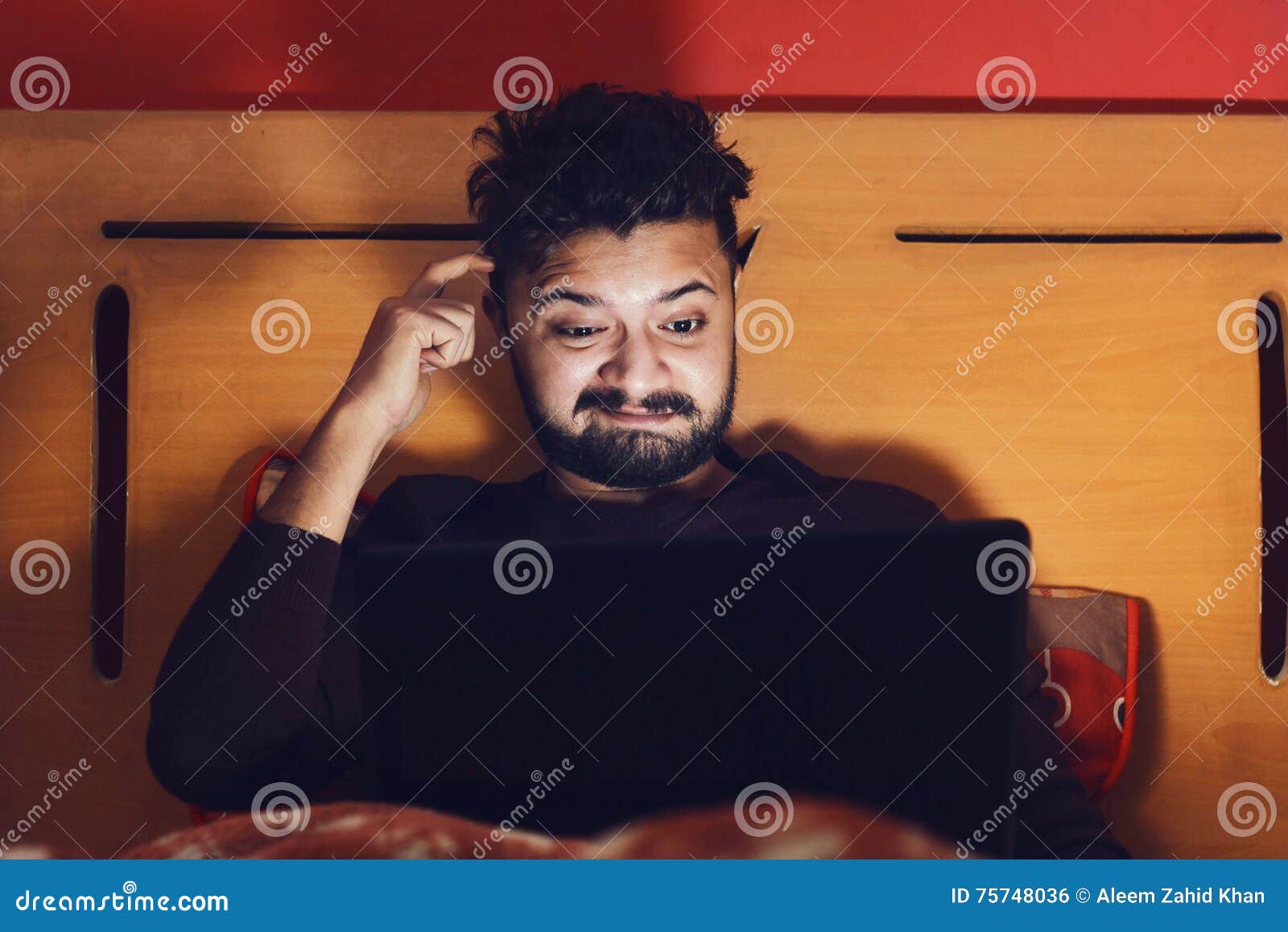 Confused Young Man Looking at Laptop and Thinking in Dark Stock Photo ...