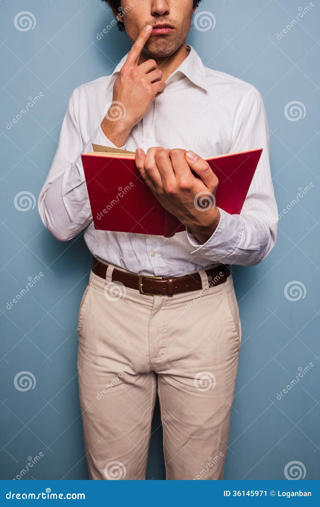 Confused Young Man Reading a Red Book Stock Image - Image of adult ...