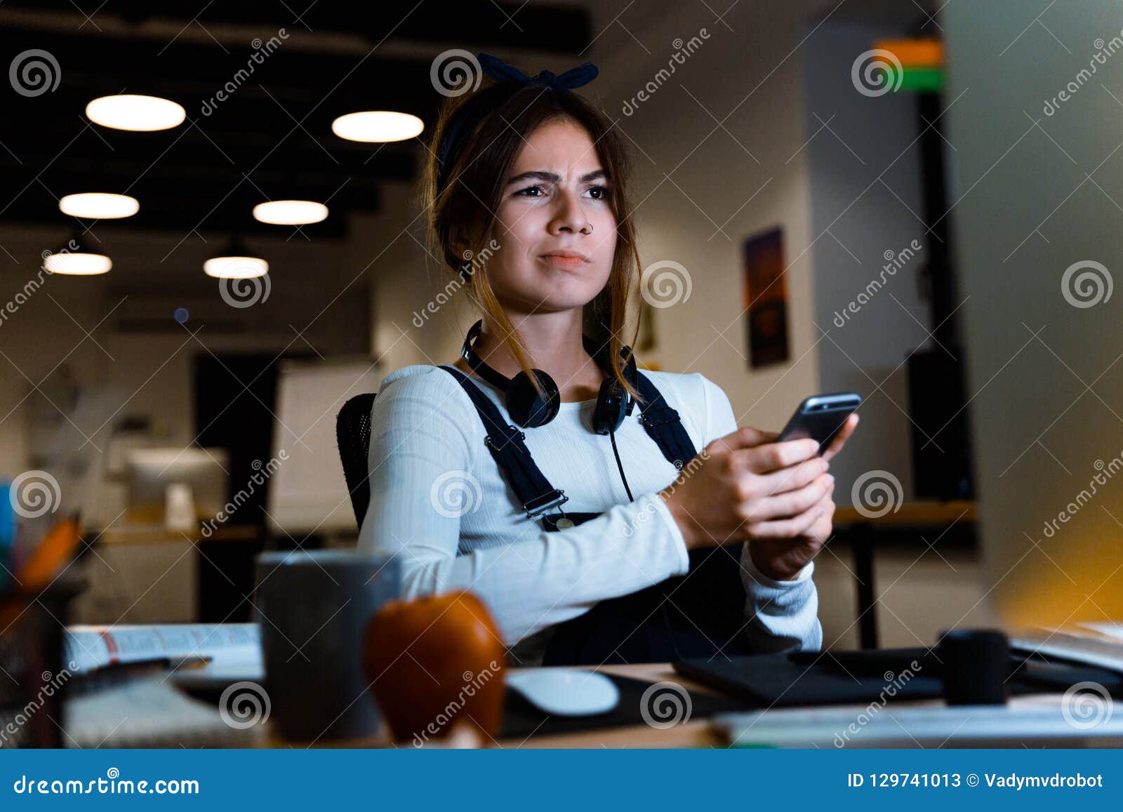 Confused Young Woman Designer Sitting in Office Working Using Mobile ...