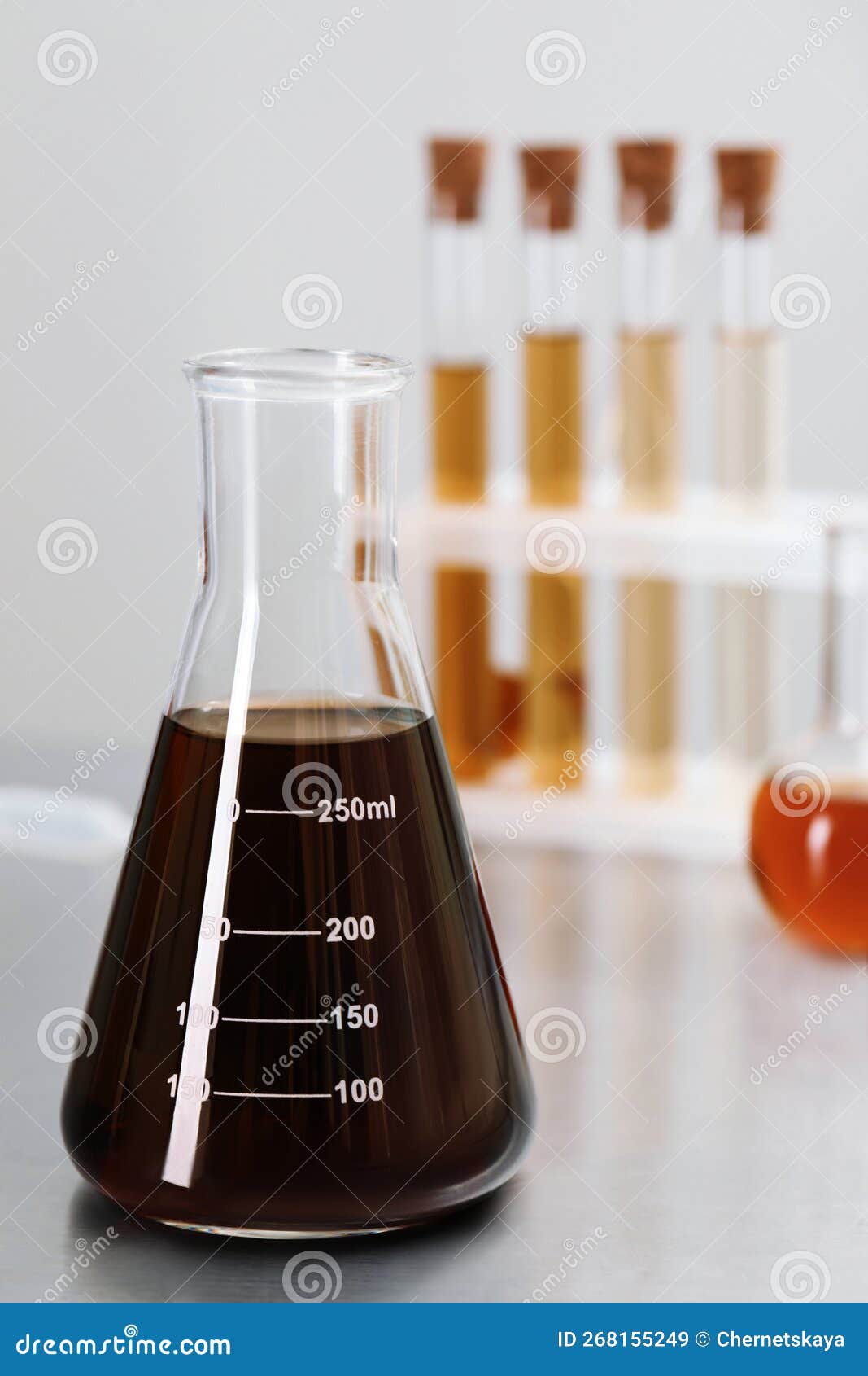 Conical Flask with Brown Liquid on Table Stock Image - Image of light ...