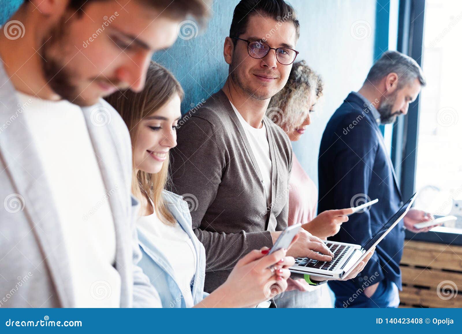 The Connected Team is an Efficient Team. Group of Businesspeople Using ...