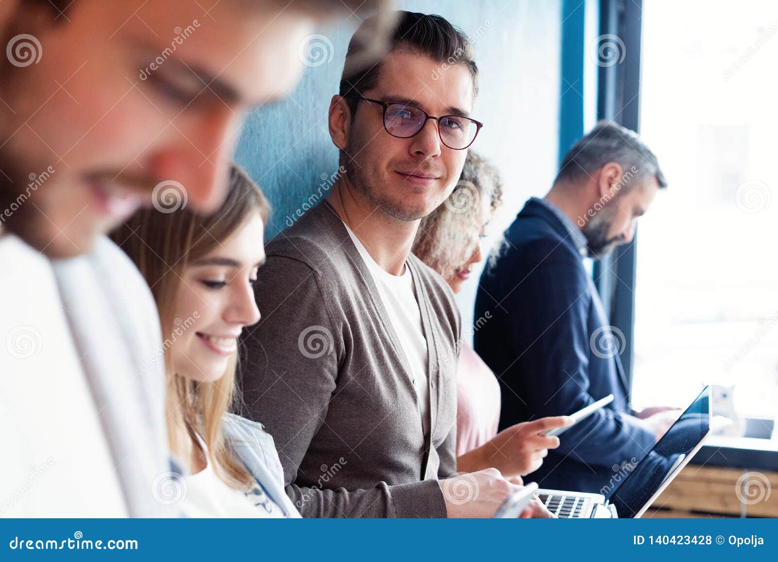 The Connected Team is an Efficient Team. Group of Businesspeople Using ...