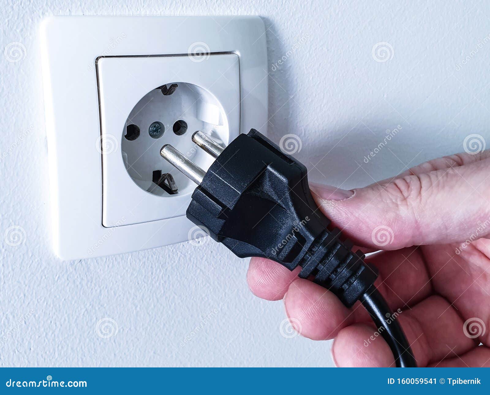 Connecting Black Electrical Power Plug With A Hand Inside A White ...