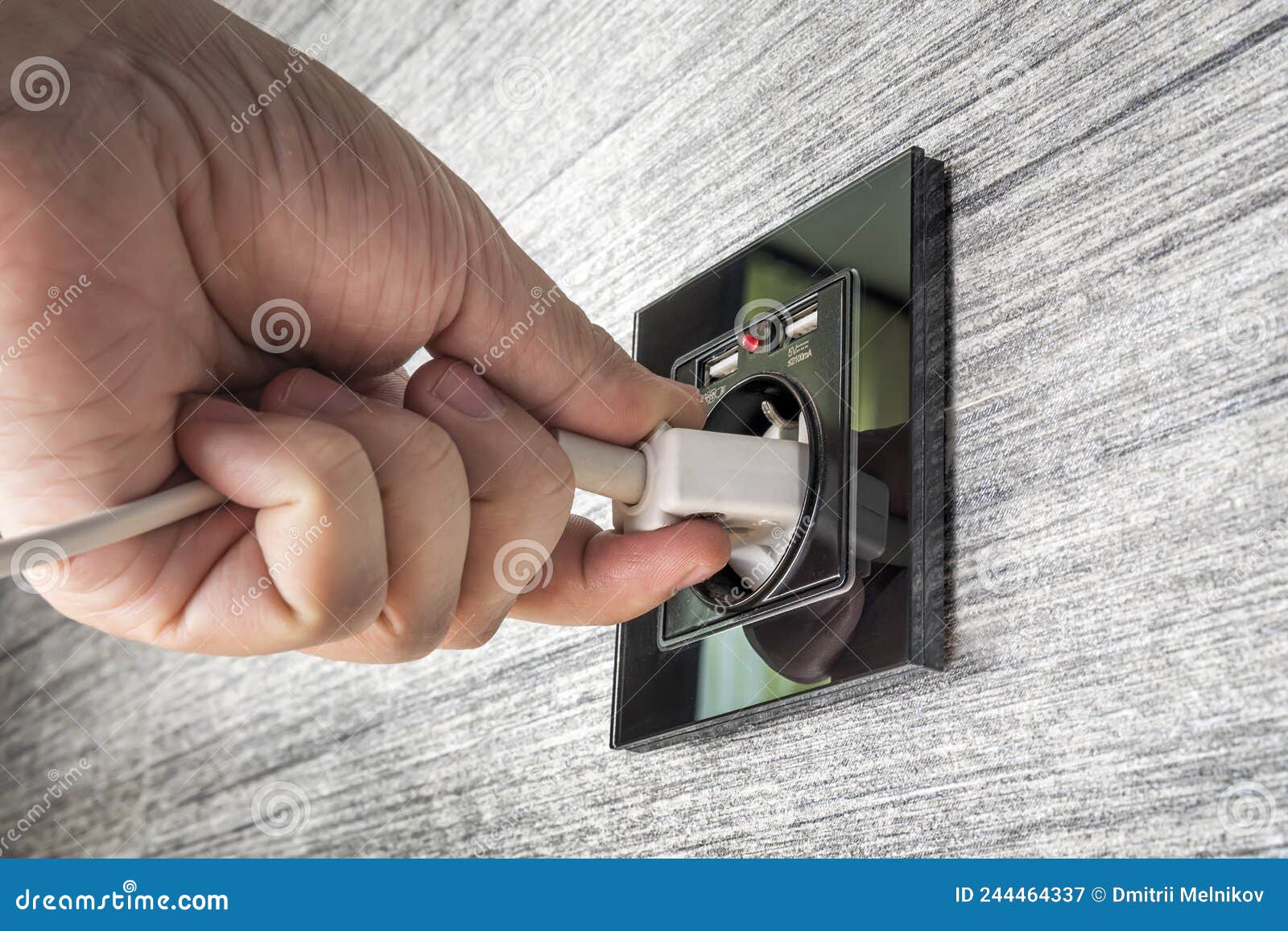 Connecting To the Power Supply on the Wall from an Outlet. Hand Putting ...