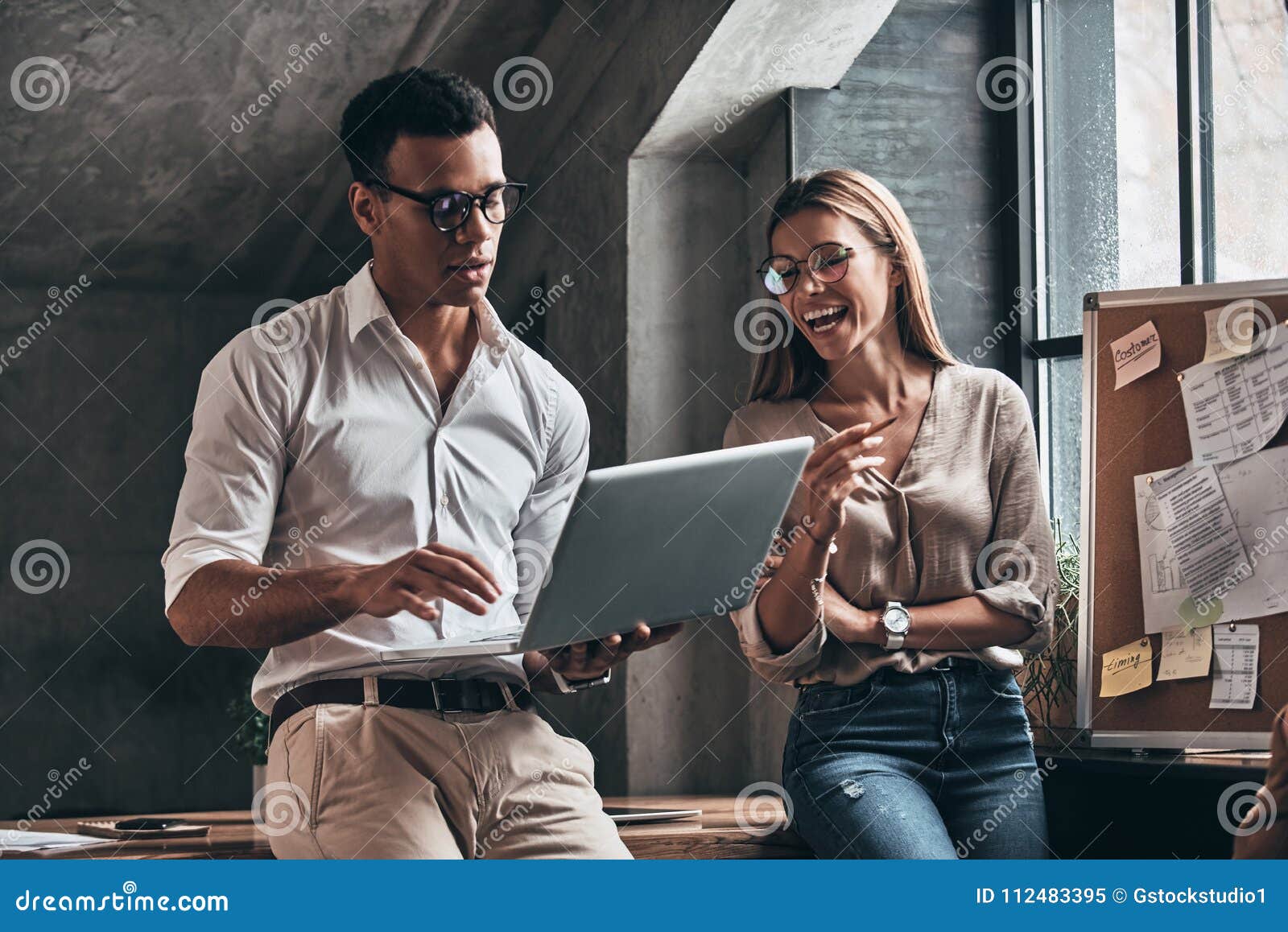 Considering New Proposal. Two Young Business People Using Comput Stock ...