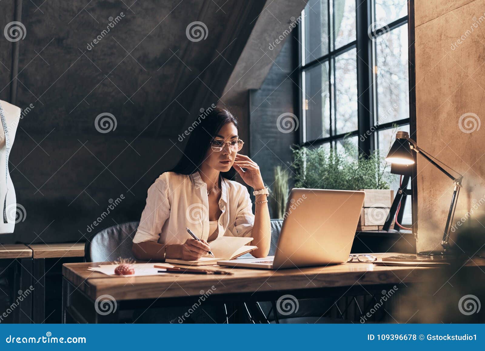 Considering the Next Step. Concentrated Young Woman Checking Out Stock ...