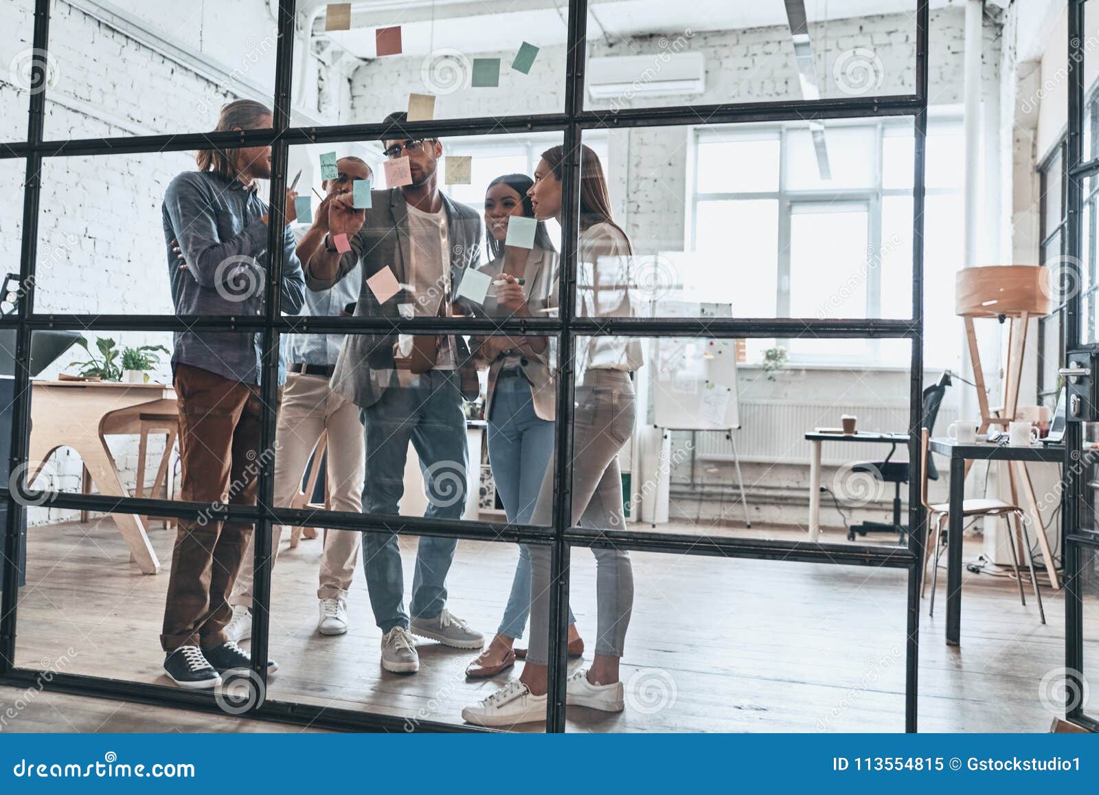 Considering the Next Step. Full Length of Young Modern People in Stock ...