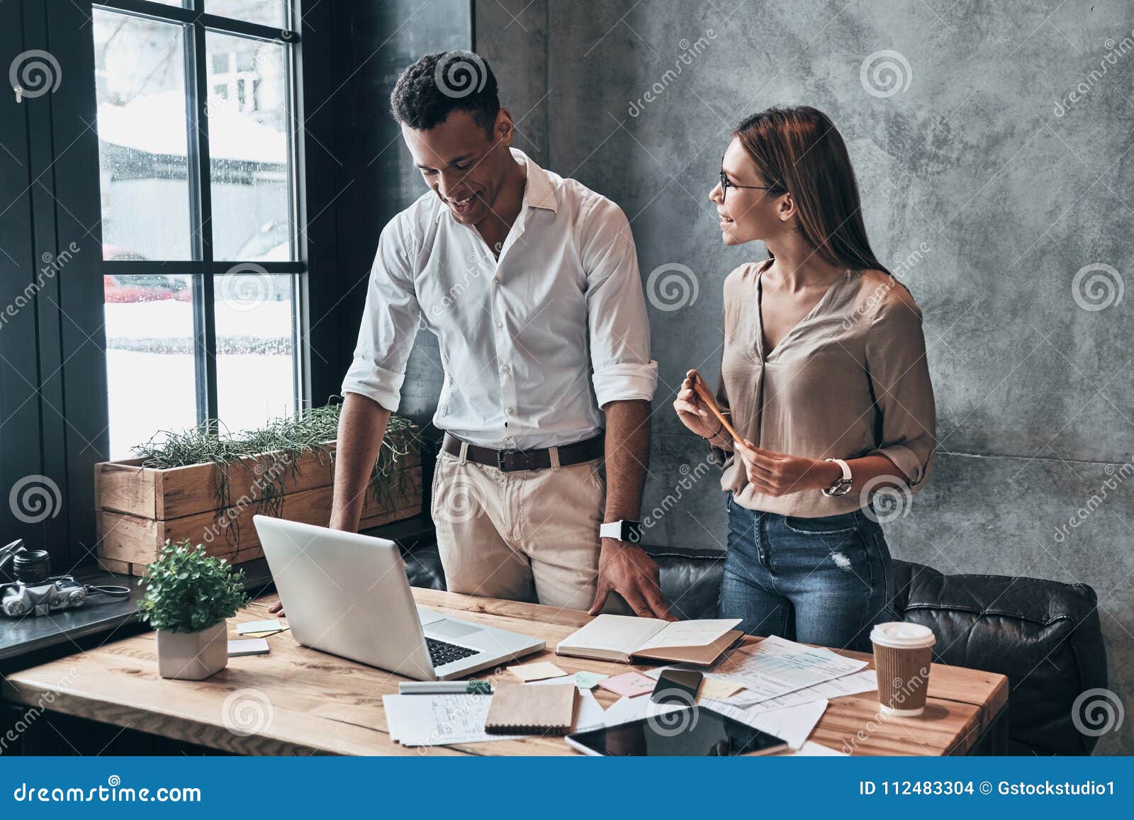 Considering the Next Step. Young Confident Business People Using Stock ...