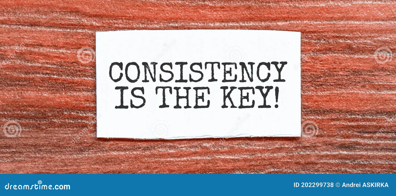 Consistency is the Key Text on the Piece of Paper on the Red Wood ...