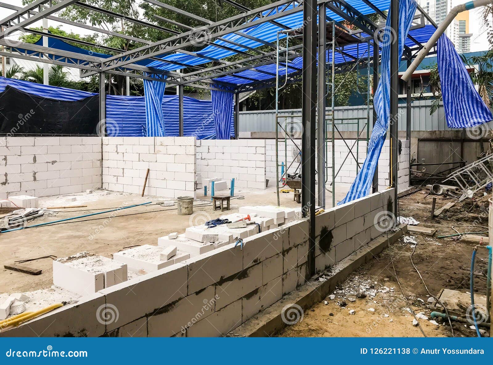 Constructing Brick Wall on a Building with Metal Foundation Stock Photo ...