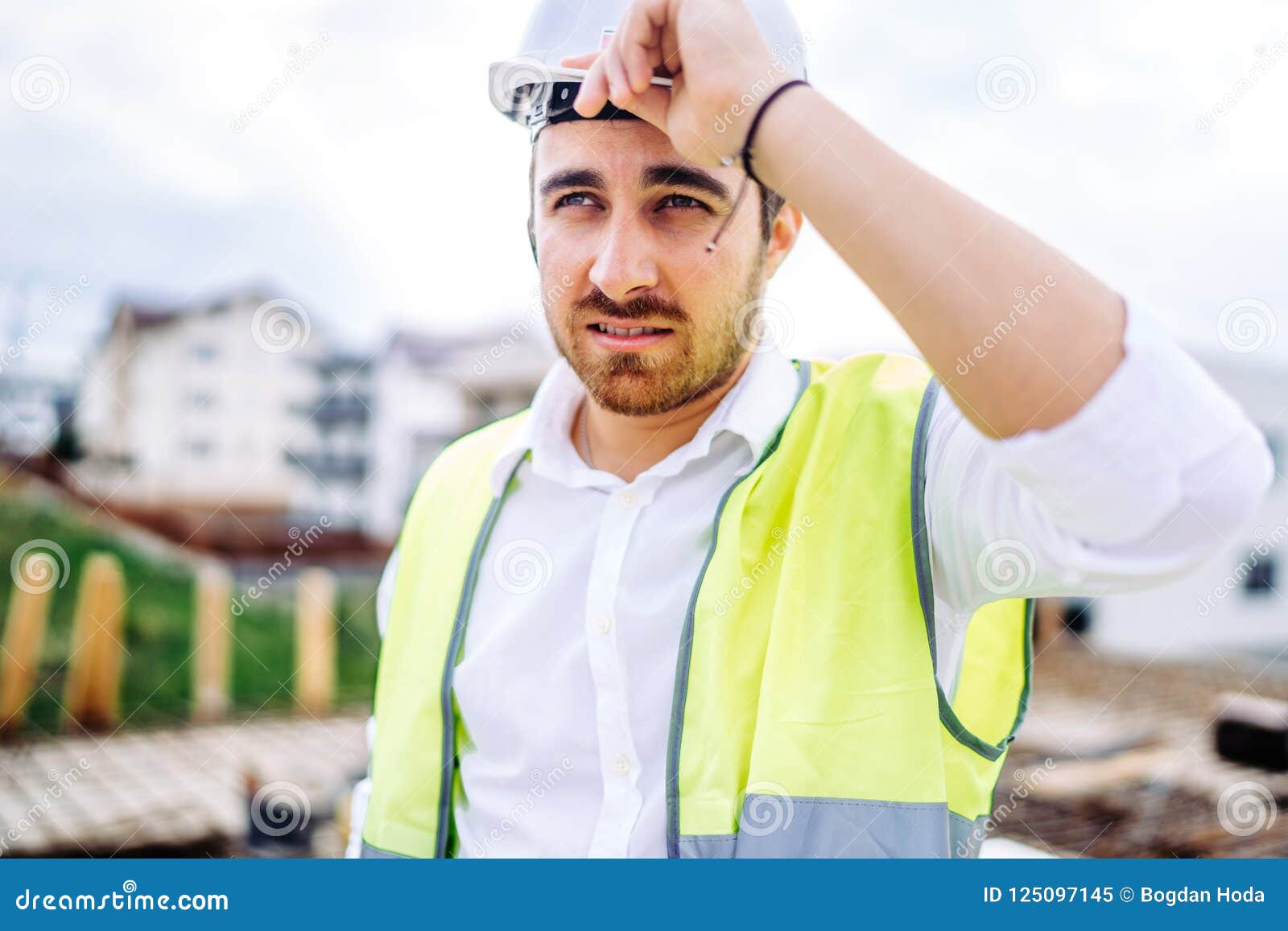 Architect Working on Construction Site, Wearing Hard Hat and Safety ...