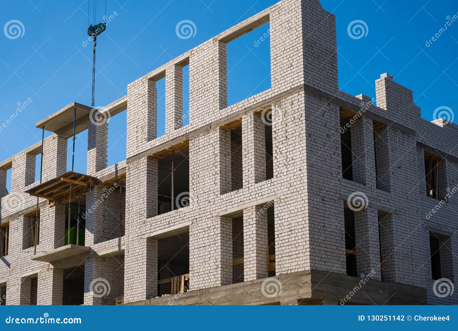 Construction of a Brick Multi-storey Building Against the Blue Sky ...