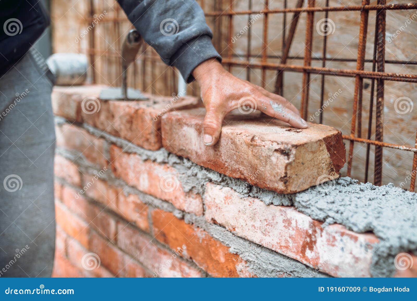 Bricklayer Placing and Adjusting Bricks with Mortar. Professional ...