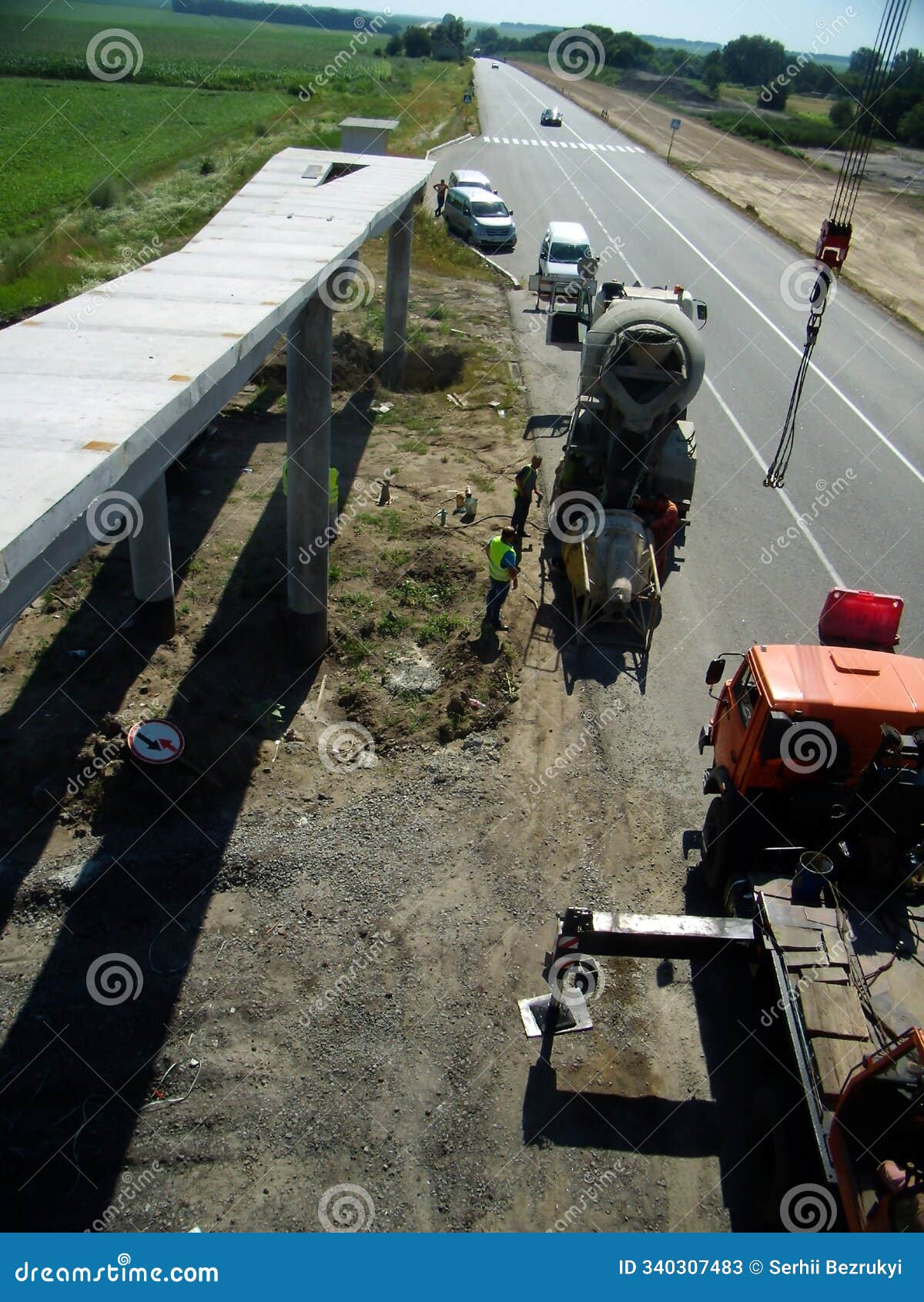 Construction of a Bridge Over a Road with a Concrete Mixer and a Crane ...