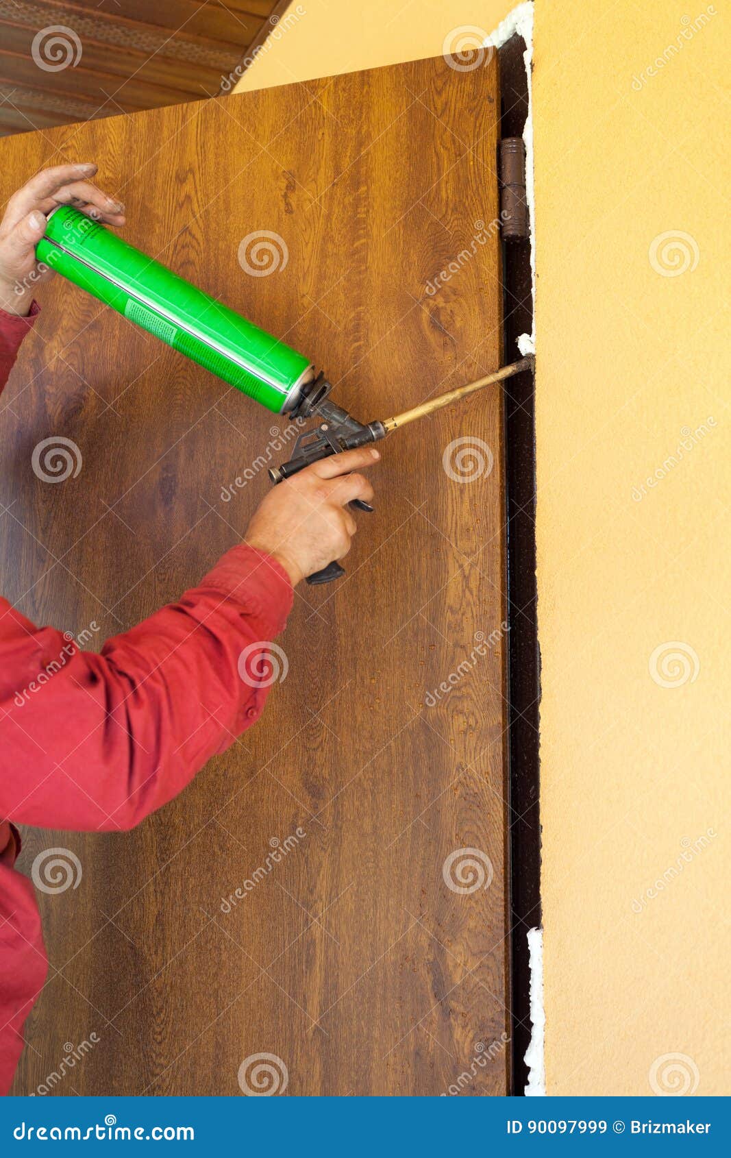 Construction Builder Works with Polyurethane Foam during Frame ...