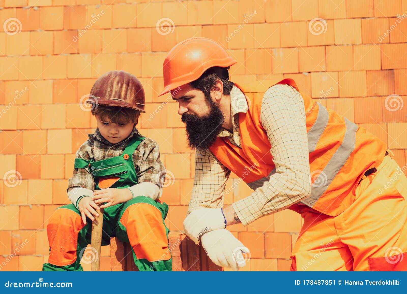 Construction Concept. Brick. Teamwork. Son Helps Father Build Brick ...