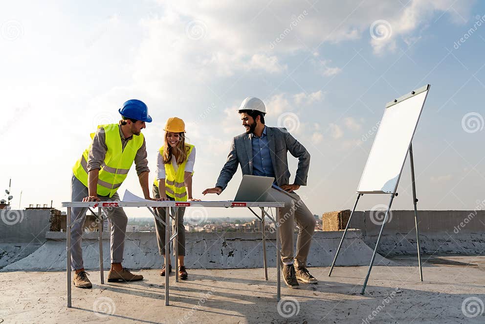 Construction Concept. Engineers and Architects Working at Construction Site with Blueprint Stock ...