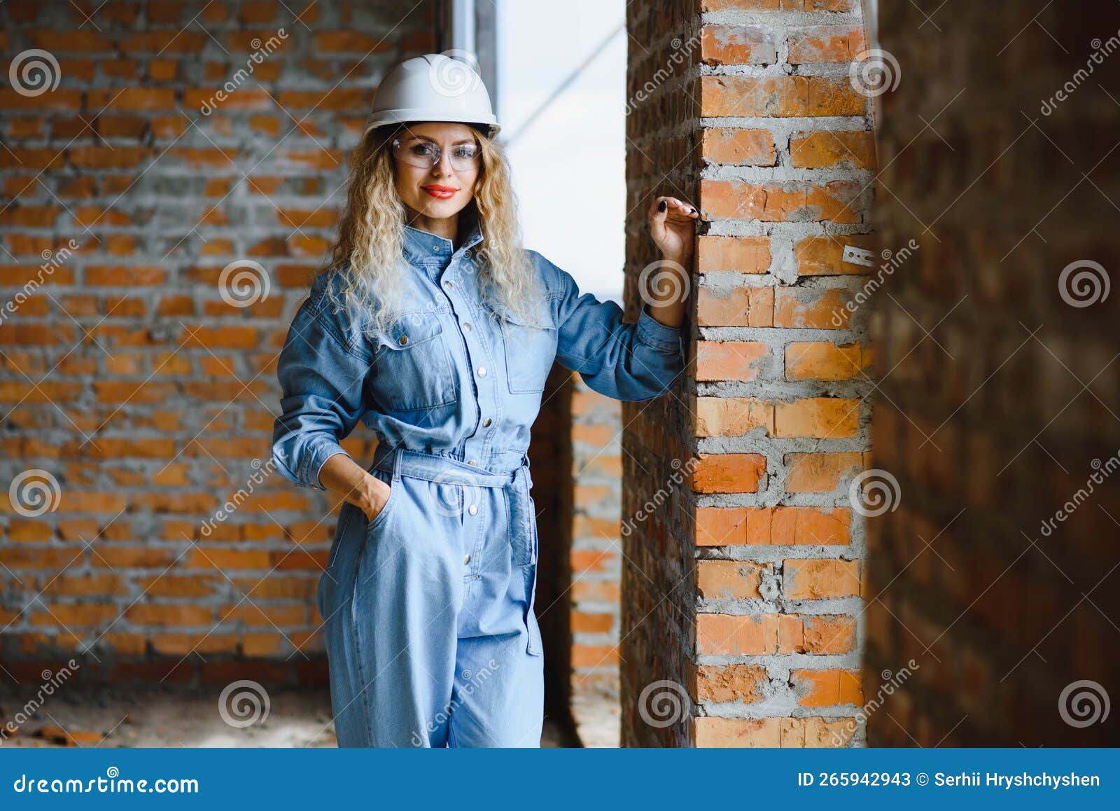 Construction Concept. Pretty Female Builder in Overalls and Helmet ...