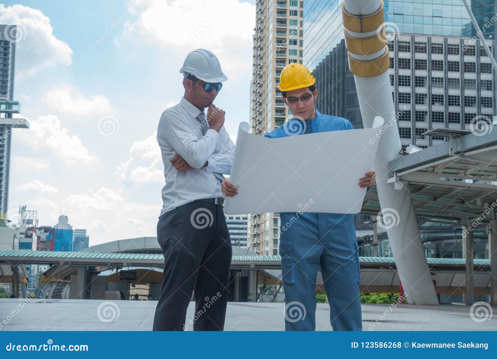 Young Businessmen and Engineers Analyzing Construction Projest. Stock ...