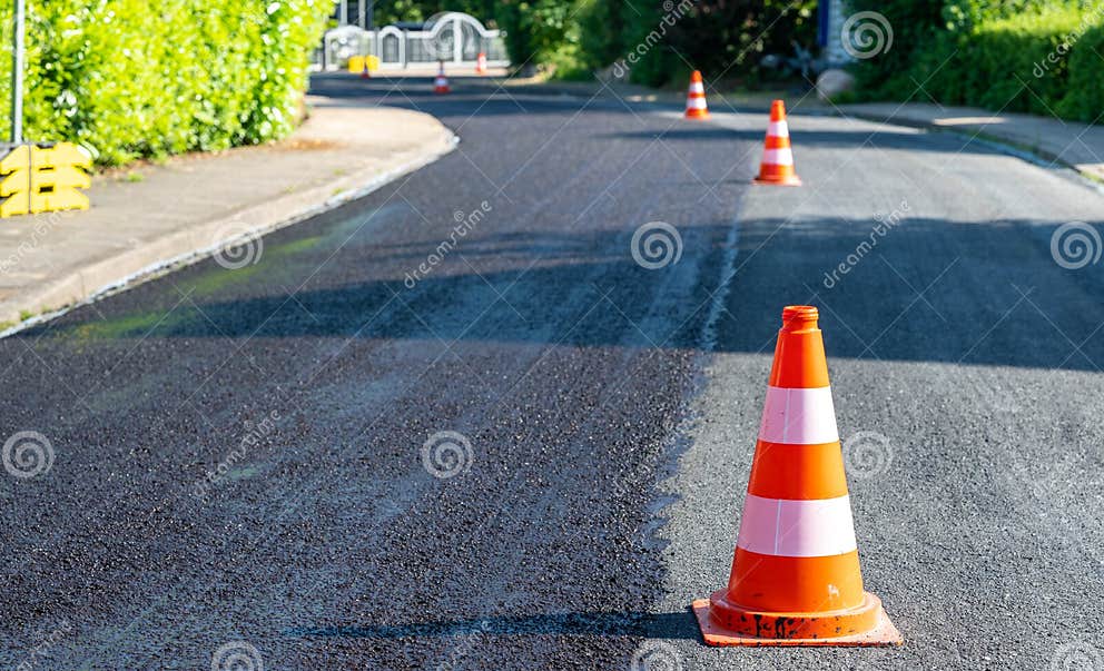 Construction Cones Marking Part of Road with a Layer of Fresh Asphalt ...
