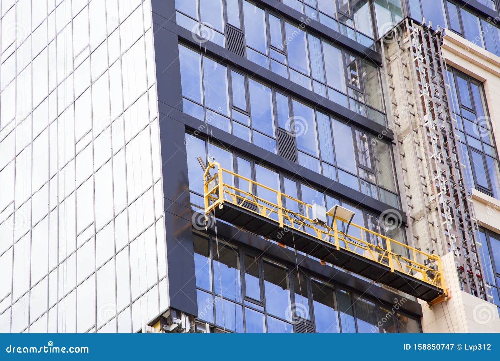 Construction Cradle on the Facade of the Building Under Construction of ...