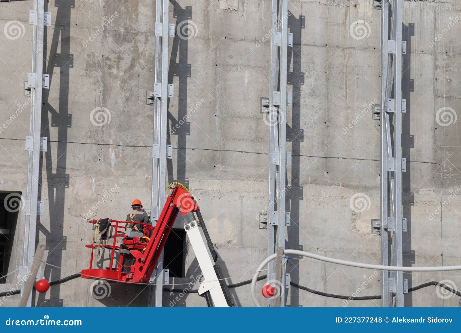 Construction Cradle with a Worker on the Wall of a Building Under ...