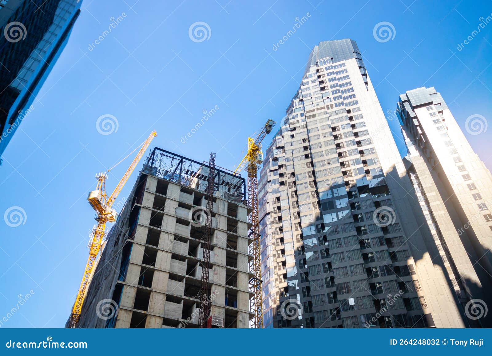 Construction Crane is Building a High-rise Building. Stock Photo ...