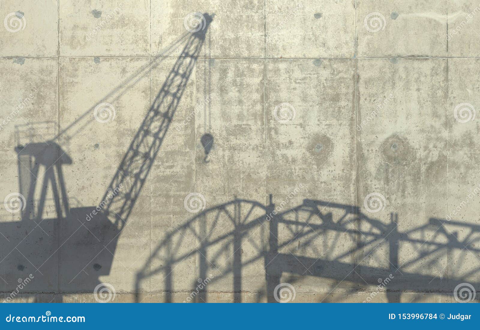 Construction Crane and Carcass of an Unfinished Building Cast a Shadow ...