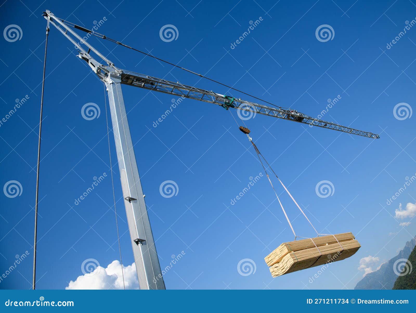Construction Crane with Hanging Load of Wood Plank Stock Photo - Image ...
