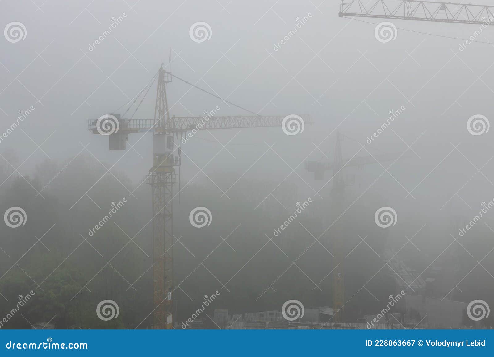Construction Crane Hidden in the Fog at a Construction Site. Building ...